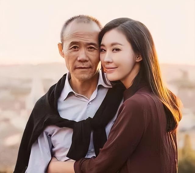 Wang Shi is in the same frame as his 30-year-old wife. The woman uses scissors to help her ...