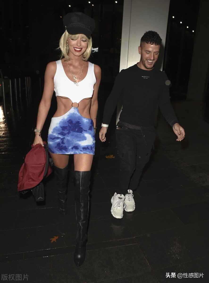 Mora Higgins: Wearing a short cutout skirt, blonde hair and red lips ...