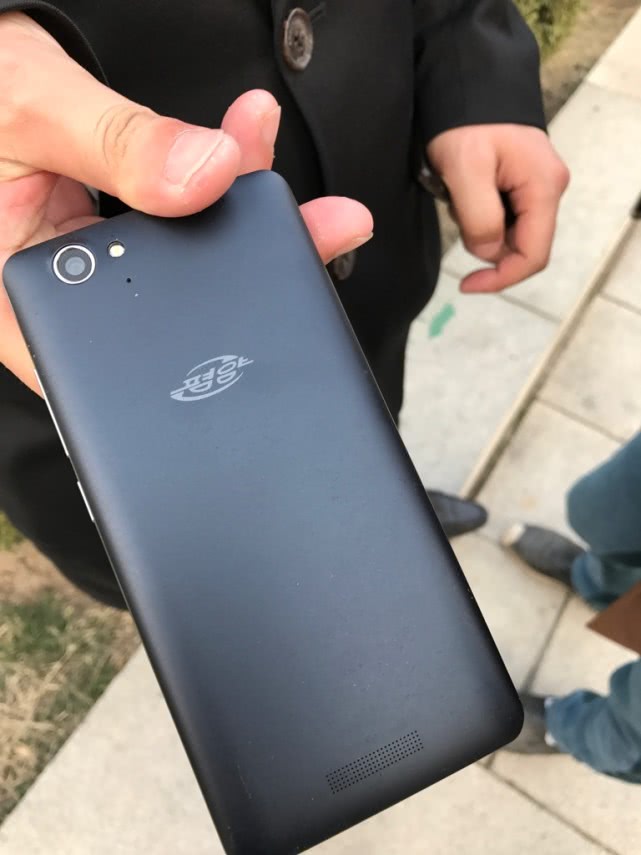 Passers-by on the streets of North Korea look down at their mobile ...