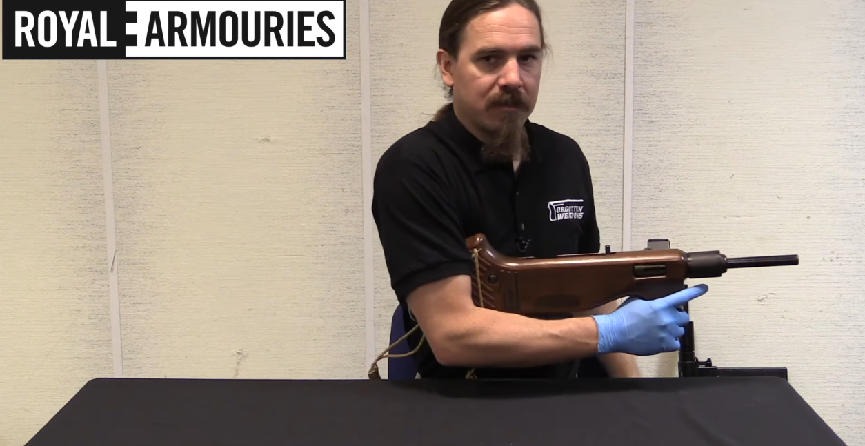A close relative of the Stern submachine gun, the British one-handed ...