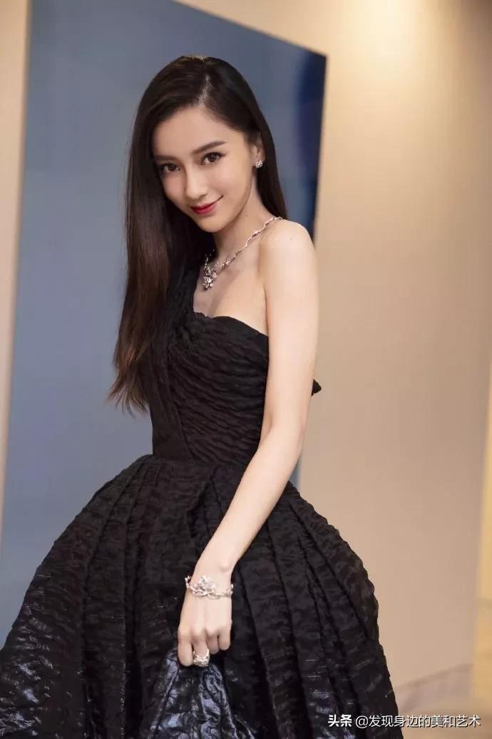 Angelababy's long-haired shawl has fair skin and is wearing a black ...