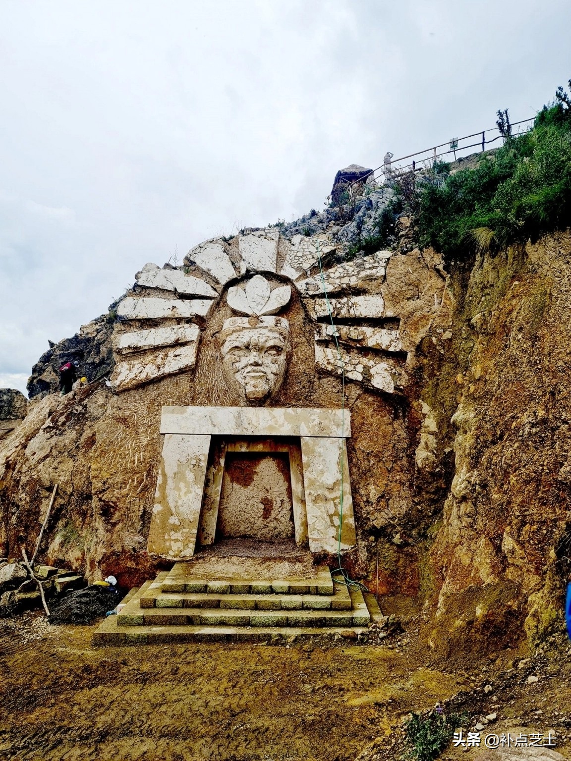 The artist chiseled a huge stone statue on the mountain wall to show ...
