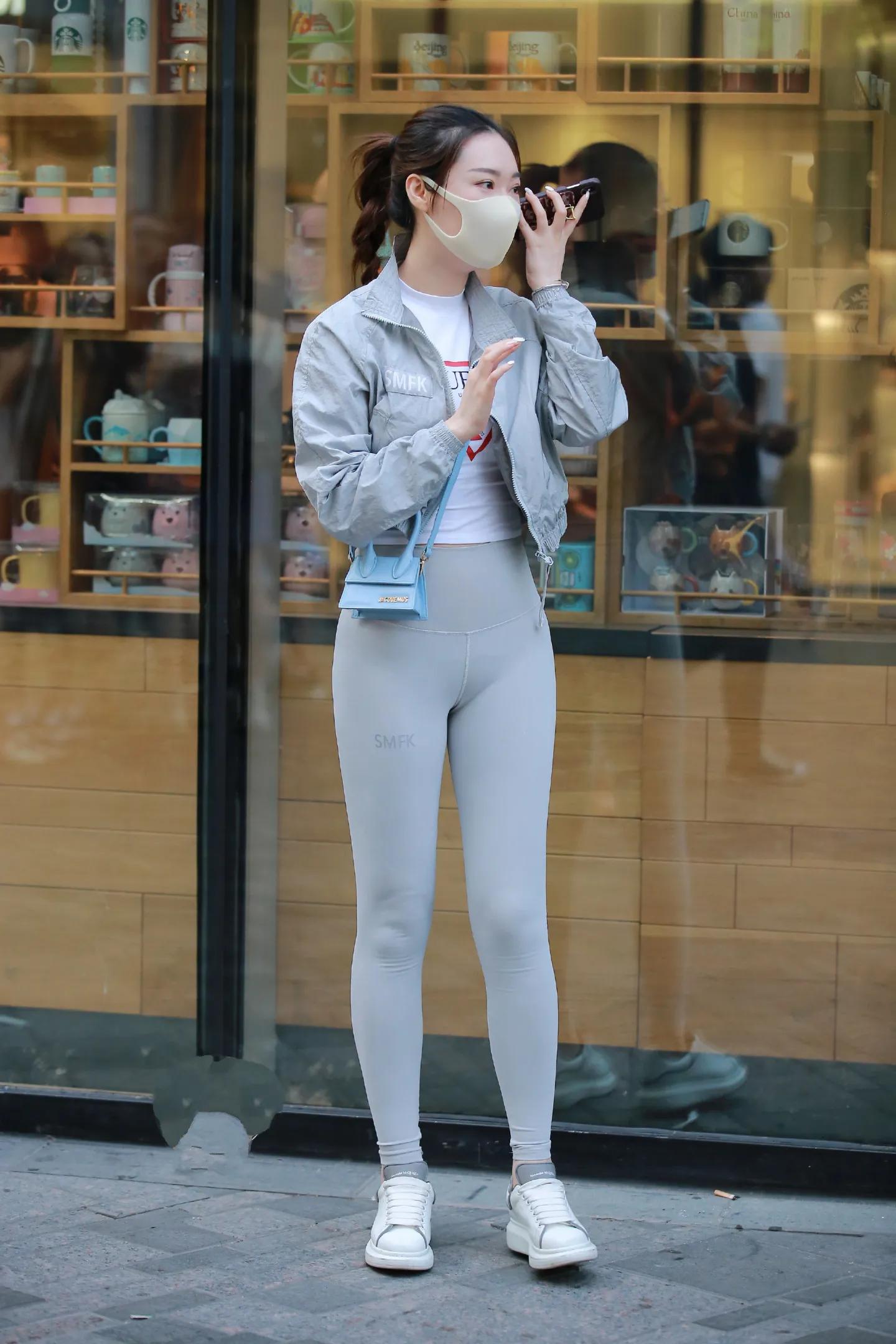 Stylish Street: Girl in gray yoga pants, wearing a mask, also covering ...