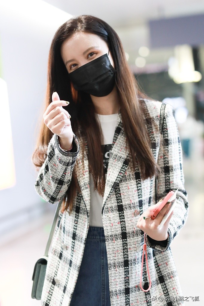 Zhang Meng wears a checkered suit jacket with a denim skirt and a ...