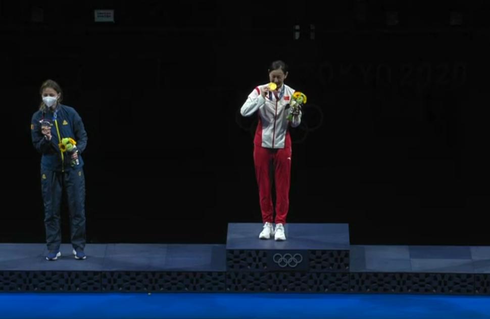 Why do Olympic gold medalists like to "bite" the gold medal when ...