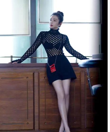 48-year-old Li Bingbing puts on leg covers to keep warm after the ...