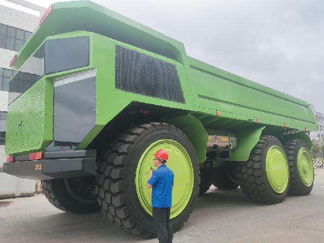 An unmanned intelligent mining truck with a load of 150 tons is off the ...