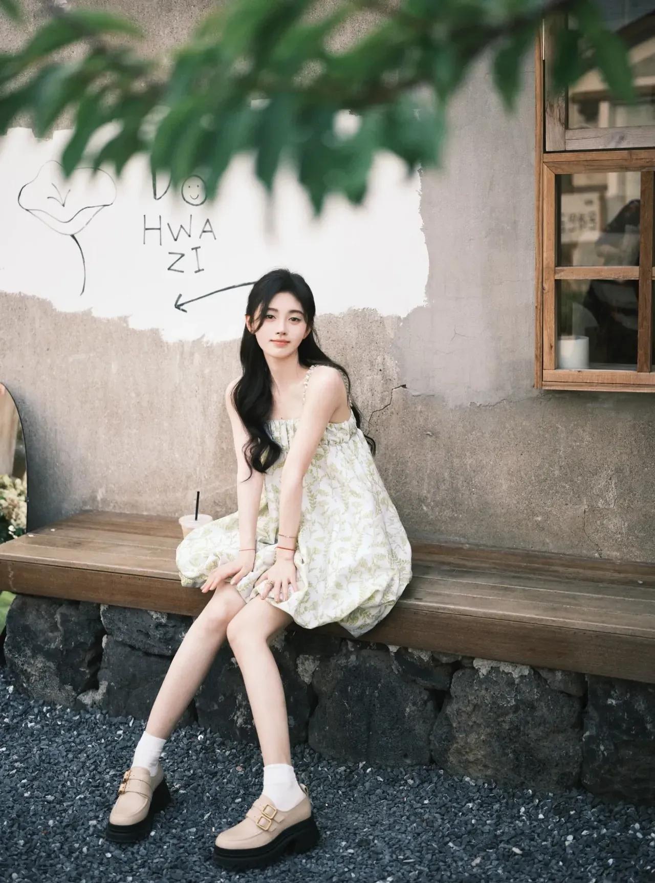 Ju Jingyi has long curly hair and a green floral suspender skirt. The ...