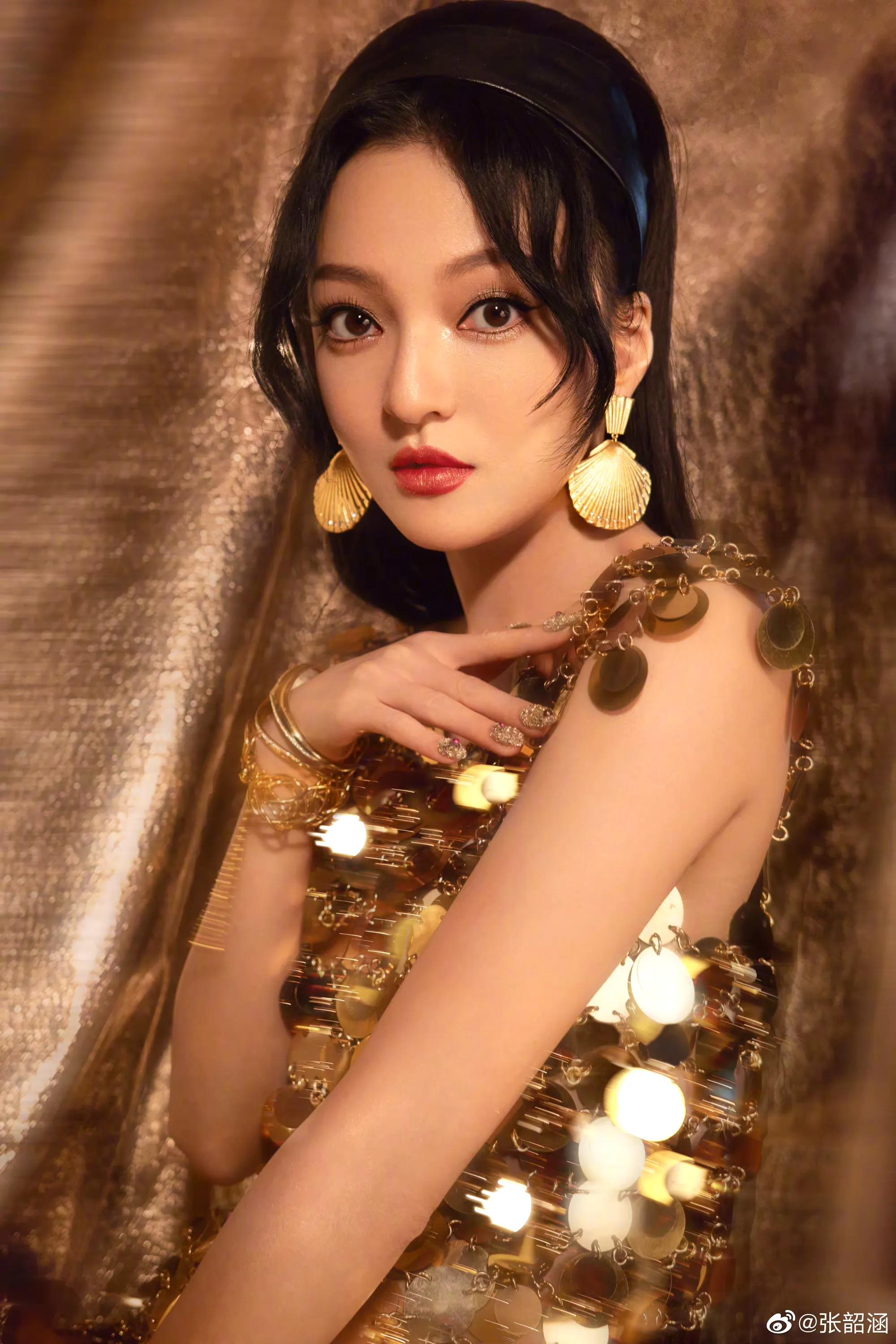 Angela Chang wears a golden sequined dress with radiant facial features ...