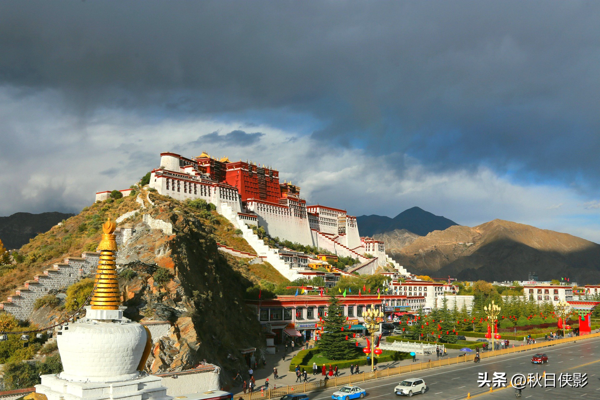 The October sun shines on the white walls of the Potala Palace, the top ...