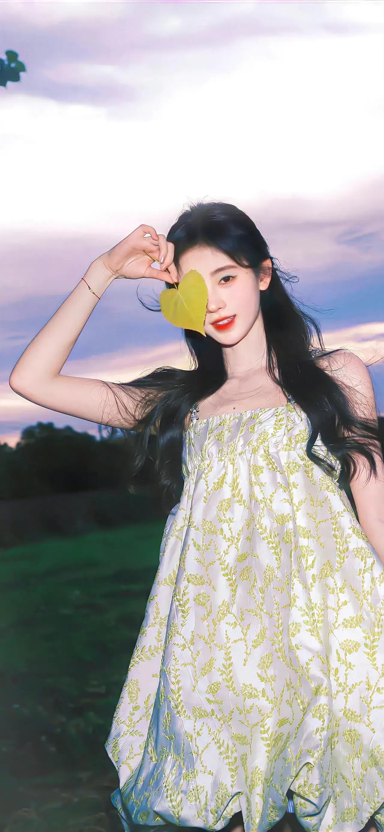 Ju Jingyi has long curly hair and a green floral suspender skirt. The ...