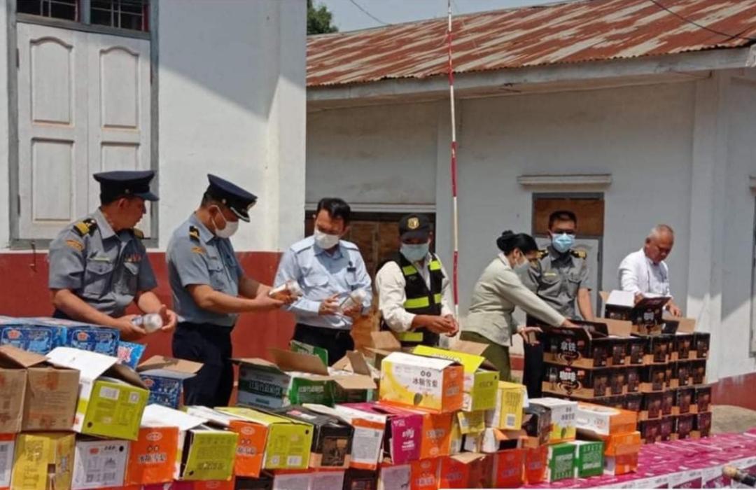 Authorities in Lashio, Myanmar focus on destroying smuggled food with a ...
