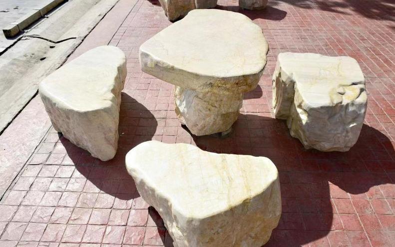 Ancient stone stone chair, carved from a large block of stone, has a ...