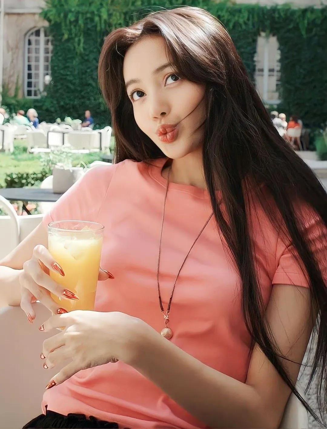 Lisa sitting on the street drinking red wine - iNEWS