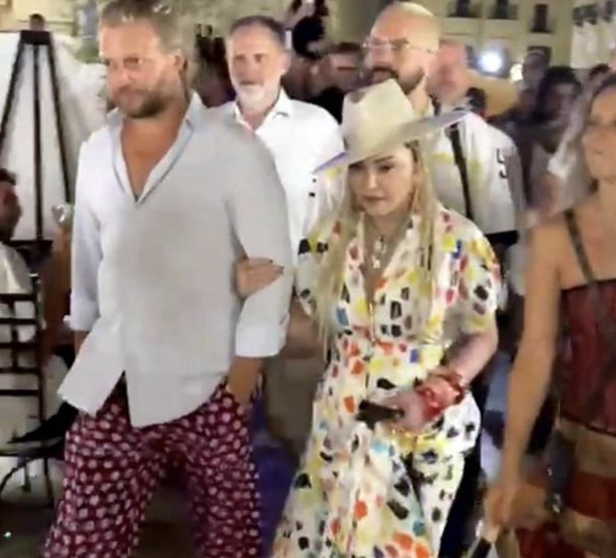 The 64-year-old Madonna and the mysterious man hold hands on the street ...