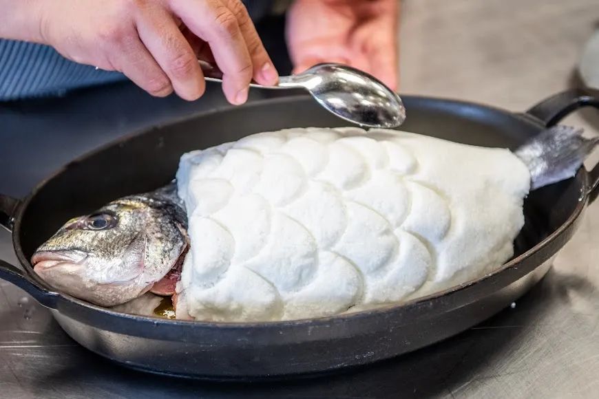 Pushing a cart of fish for customers to pick, tableside service in high ...