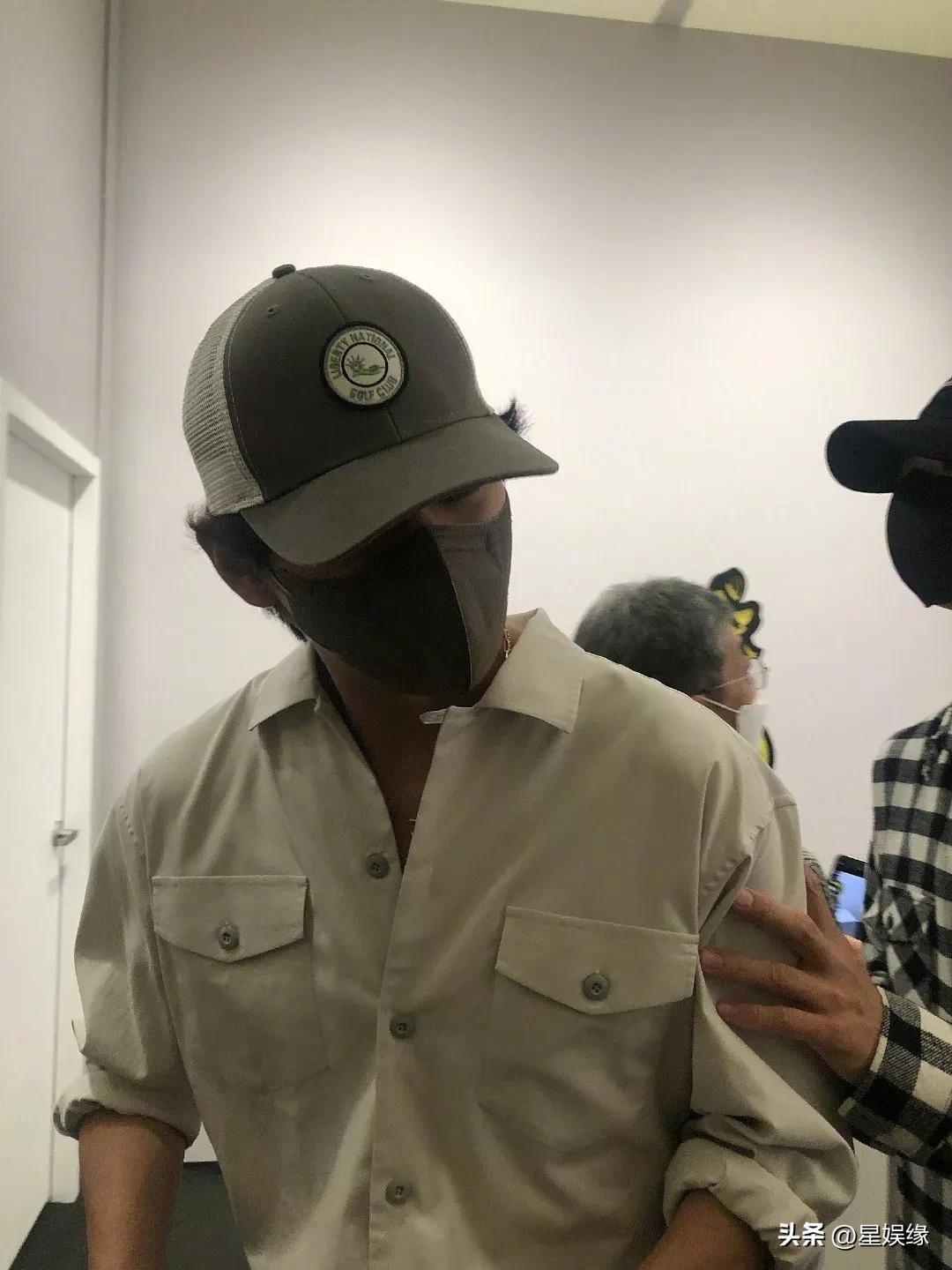 Kim Taehyung looks at the Reuters picture, off-white baseball cap ...