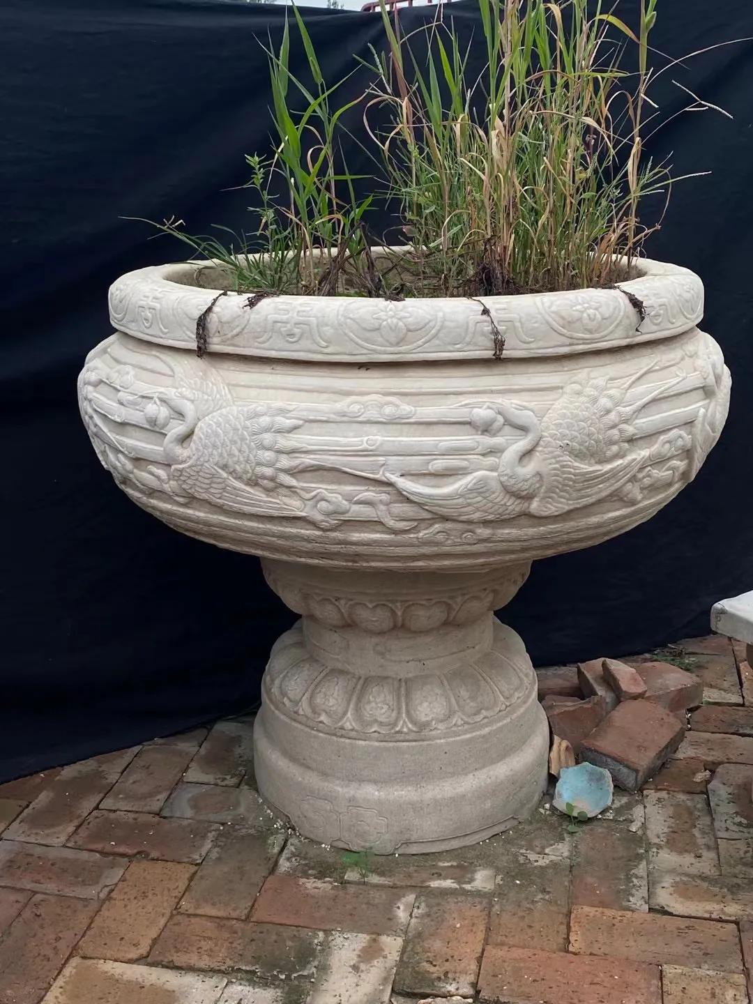 A pair of white marbles in a large stone jar - iNEWS