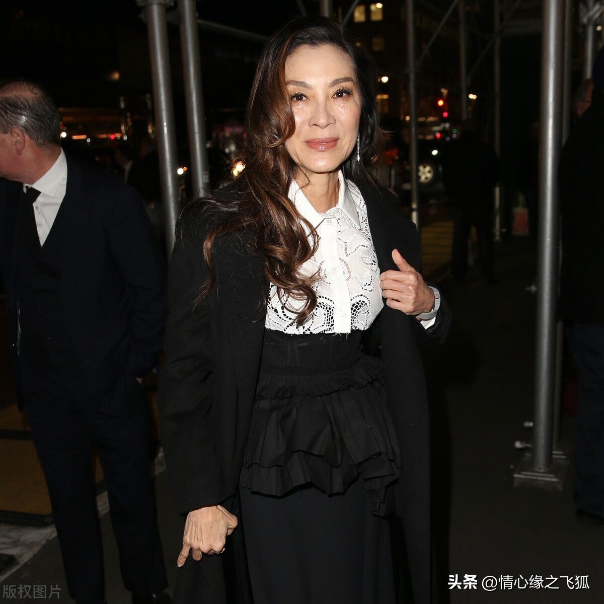 Michelle Yeoh is an elegant woman wearing a white hollow shirt + black ...