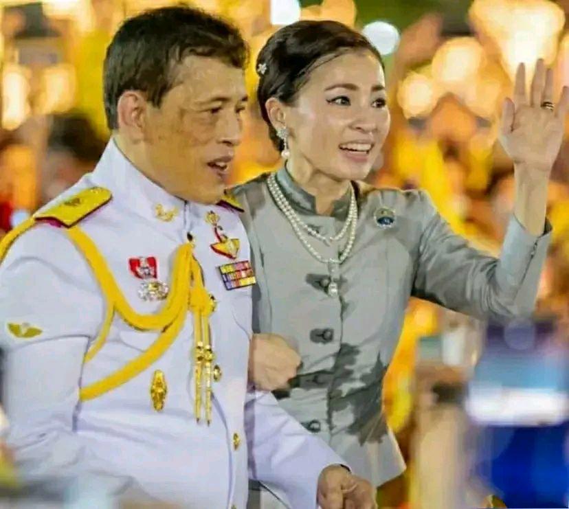 The queen of Thailand is out of makeup and her clothes are wet. She ...