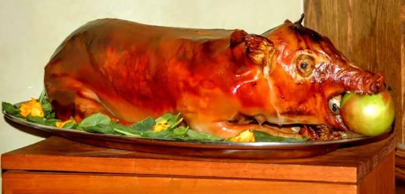What is the origin of the apple in the mouth of the roast suckling pig ...