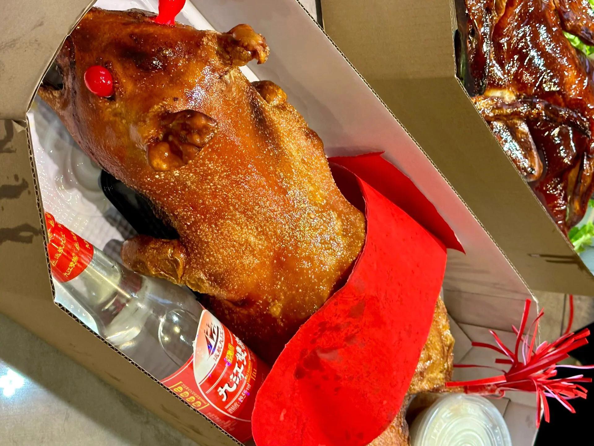 One person carries a roasted suckling pig up the mountain. The ...