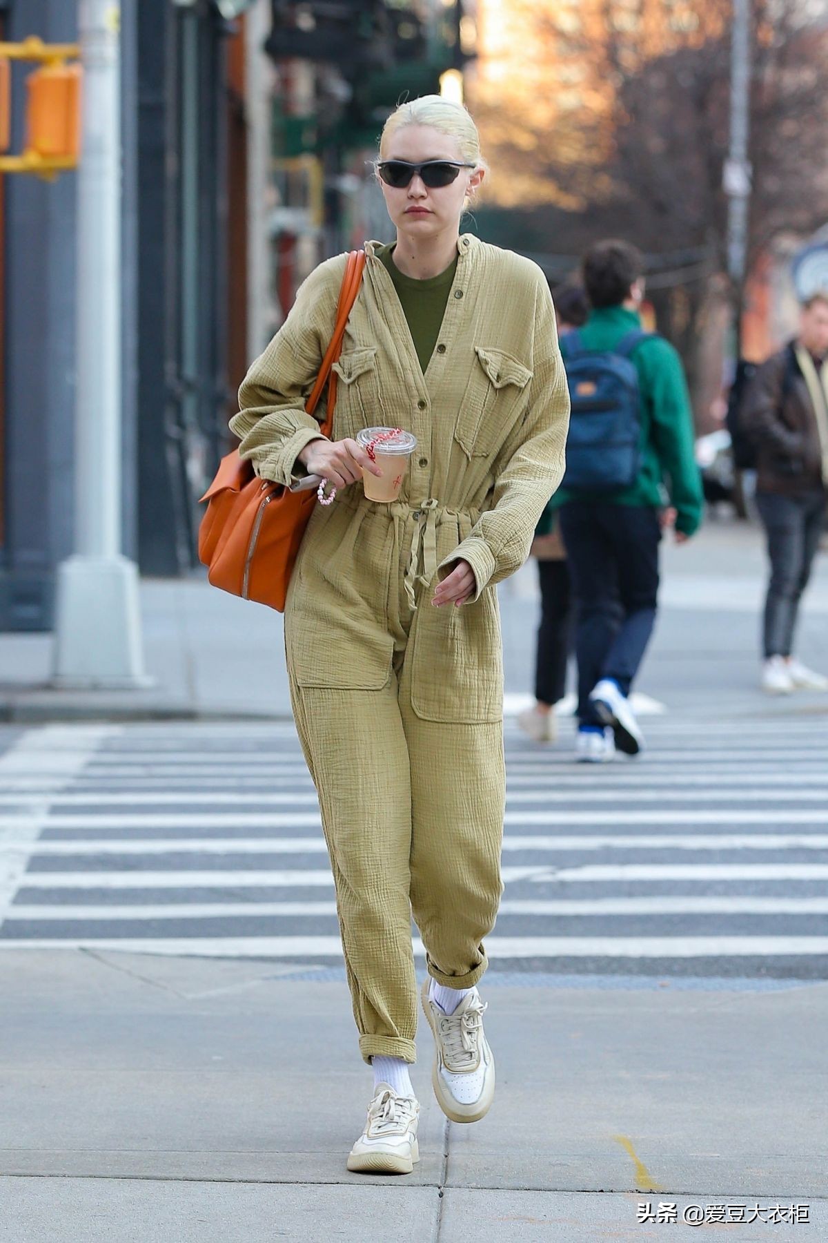 Emily wears a denim jacket and walks her dog on the street, and Woolard ...