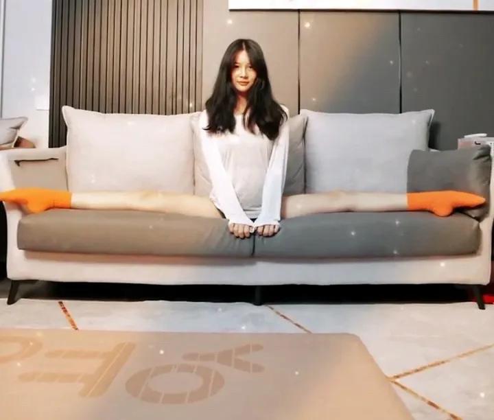 The girl stretches her legs 180 degrees, shows off the yoga horse, and ...