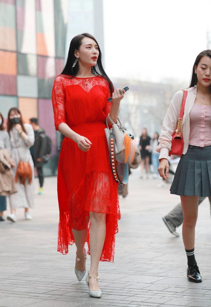 Street photo: The beautiful young lady wears a red dress, simple and ...