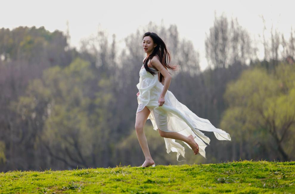 Girlfriend shows off her long legs and poses on a tree, which is of ...
