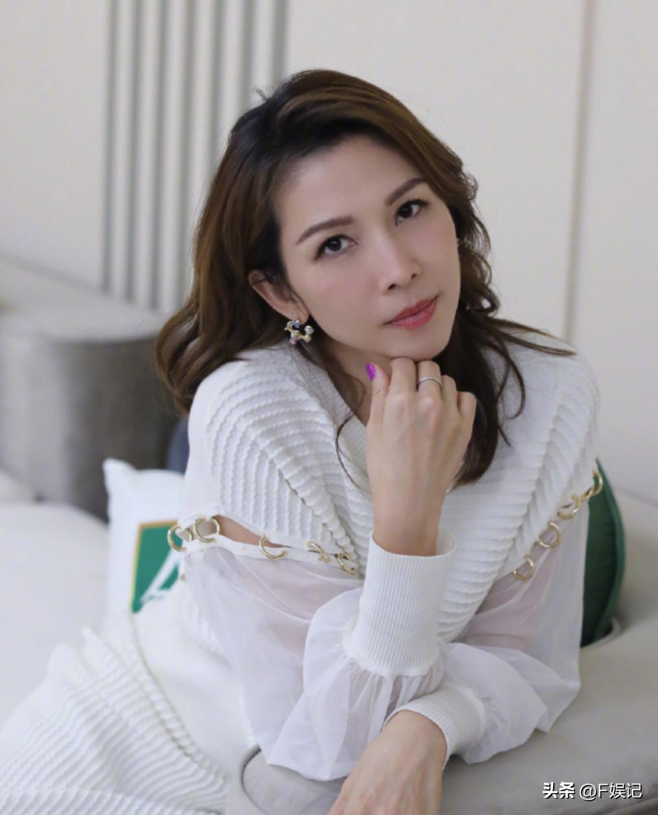 Ada Choi sits on a low stool and eats street noodle stalls chatting happily with colleagues - iMedia