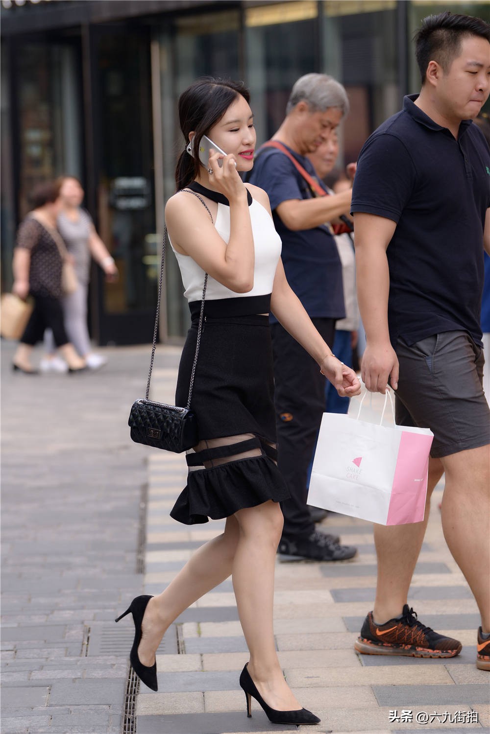 Black pointed-toe stilettos, with a black ruffled high-waisted skirt ...