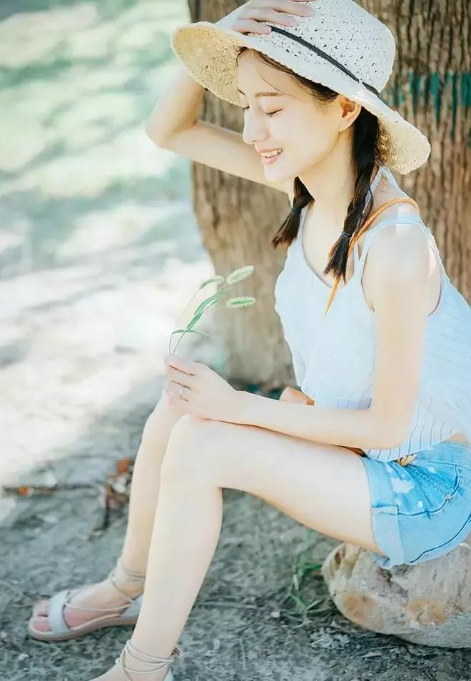 Outdoor fresh and fair-skinned beauty with pure twisted braids wearing ...