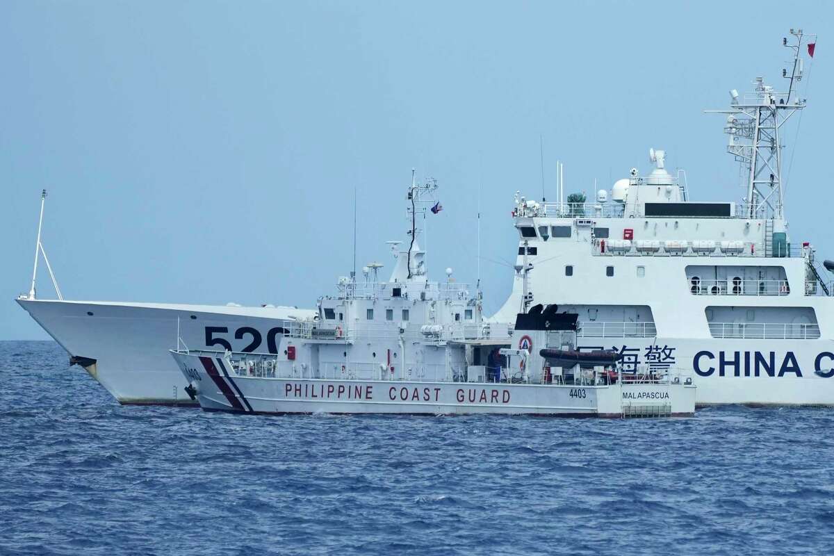 Hundreds of Chinese fishing boats are stationed at Oxbow Reef, Marcos ...