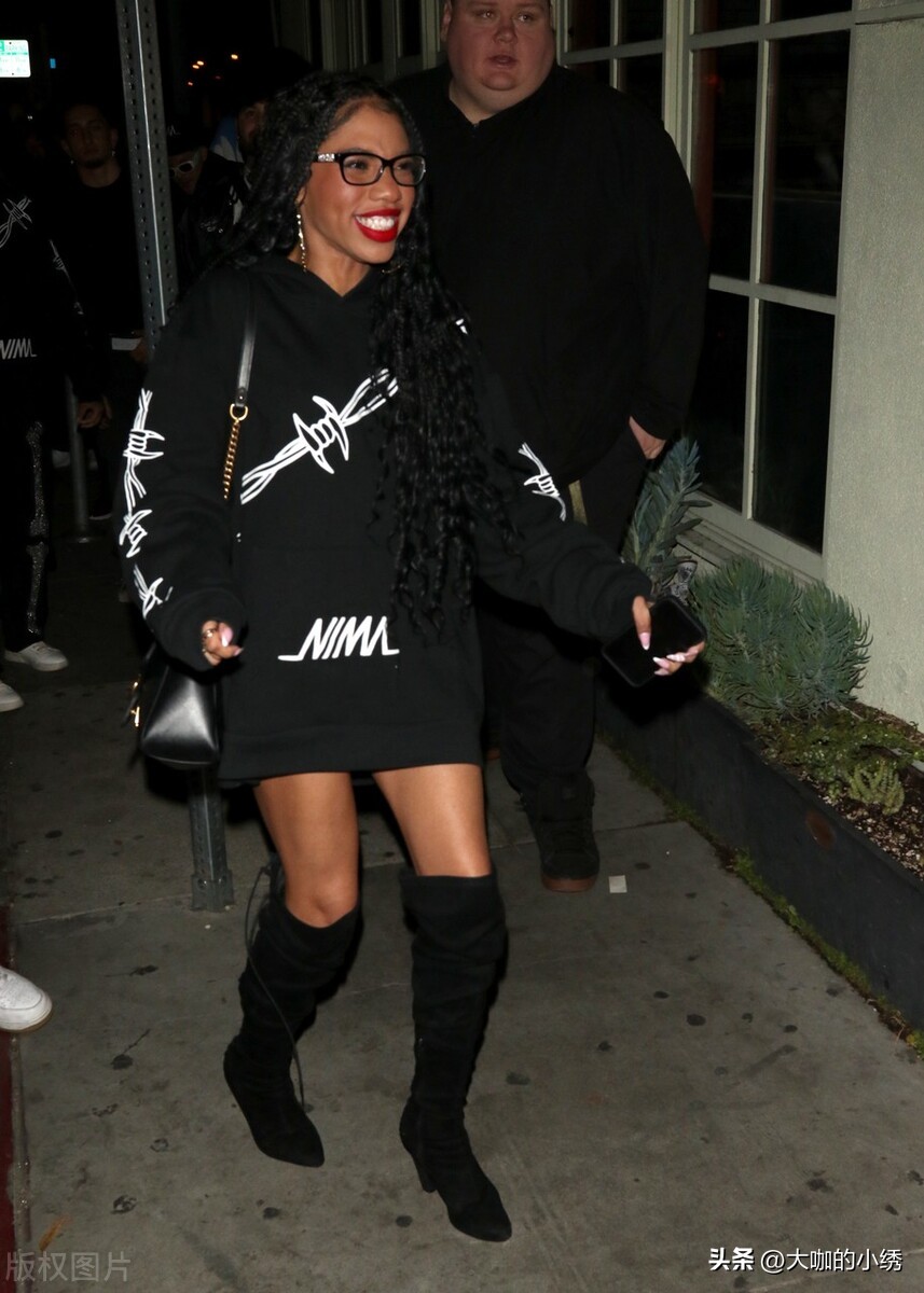 Tiara Dunn is wearing a hooded sweater + boots in modern fashion - iMedia
