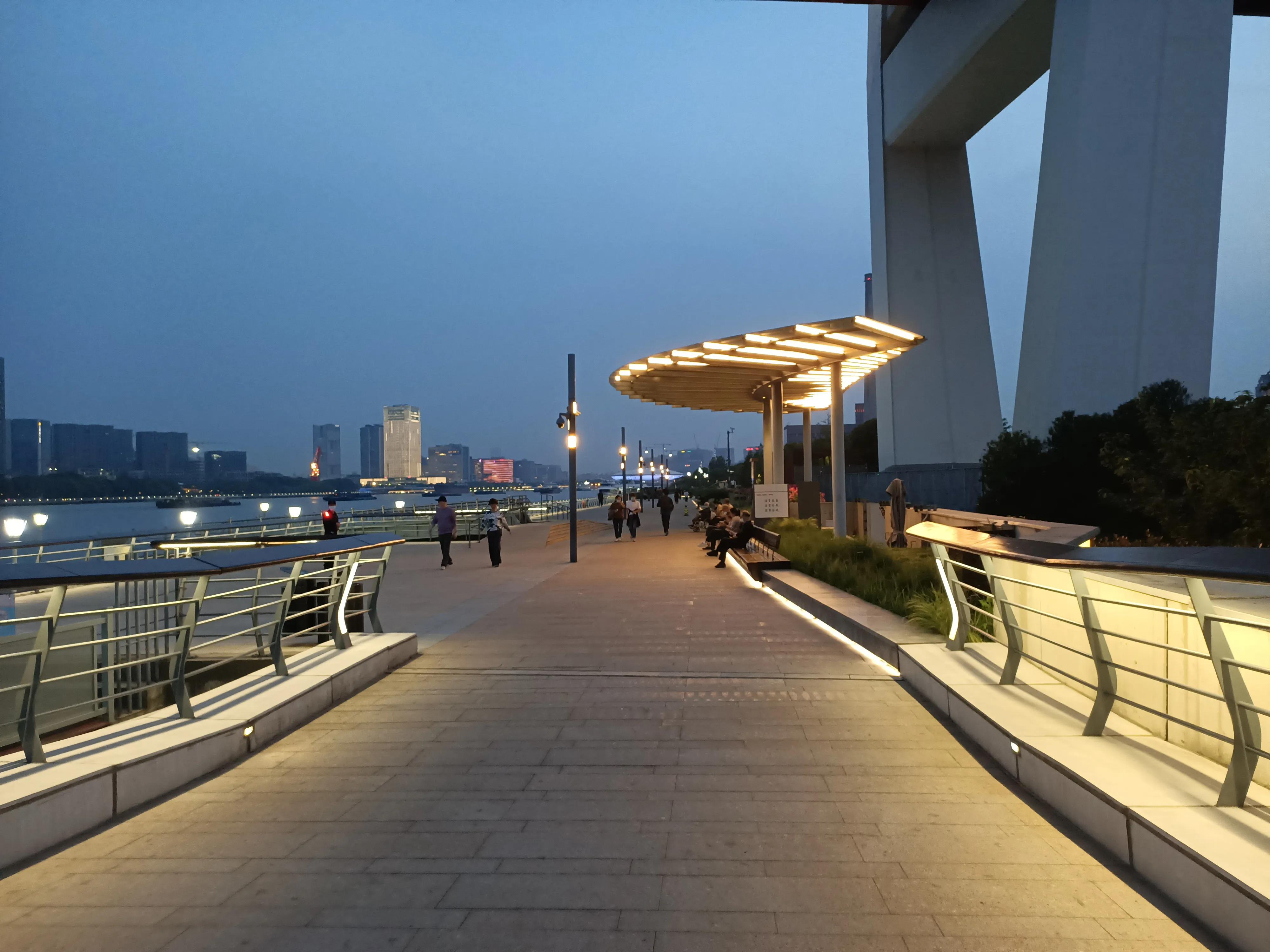 Walking along the Huangpu River in the comfortable night of early ...