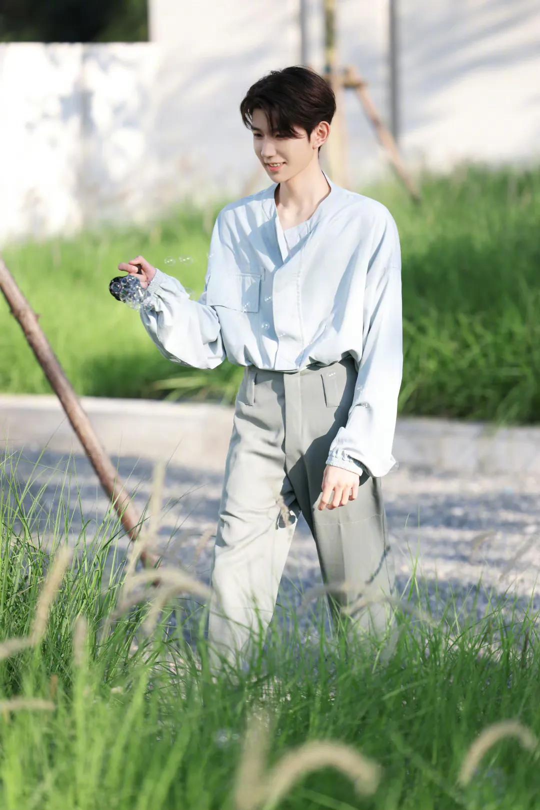 Bright sunshine, light-colored clothes, handsome young man with fresh ...