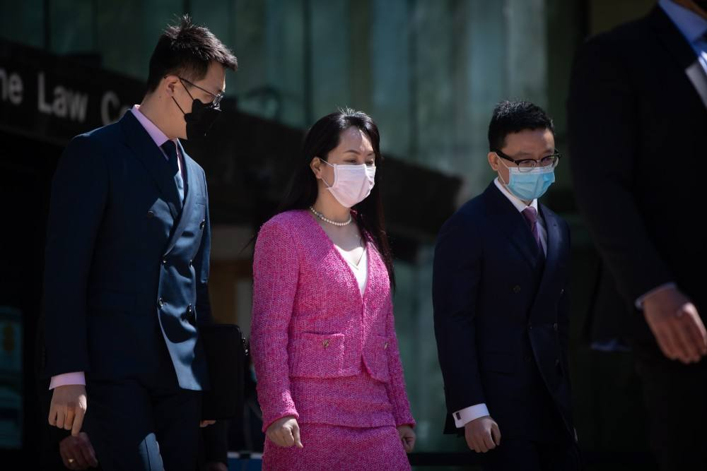 Meng Wanzhou made a high-profile appearance, wearing a pink dress and a ...