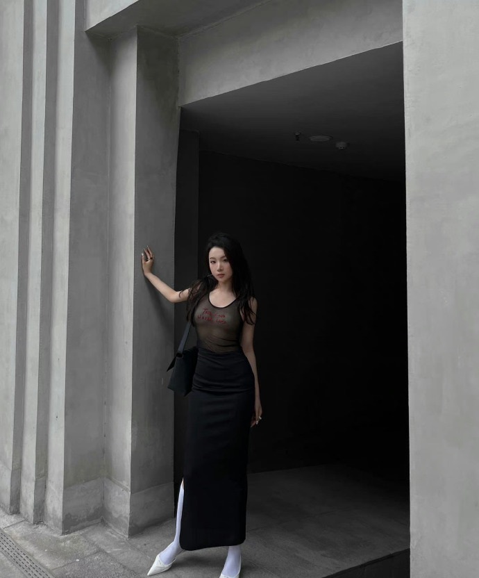 Fashionable street shot of a beautiful woman in a see-through vest and ...