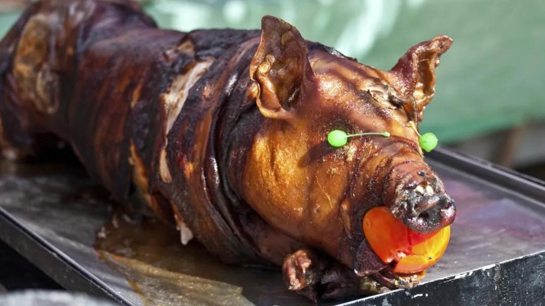 What is the origin of the apple in the mouth of the roast suckling pig ...