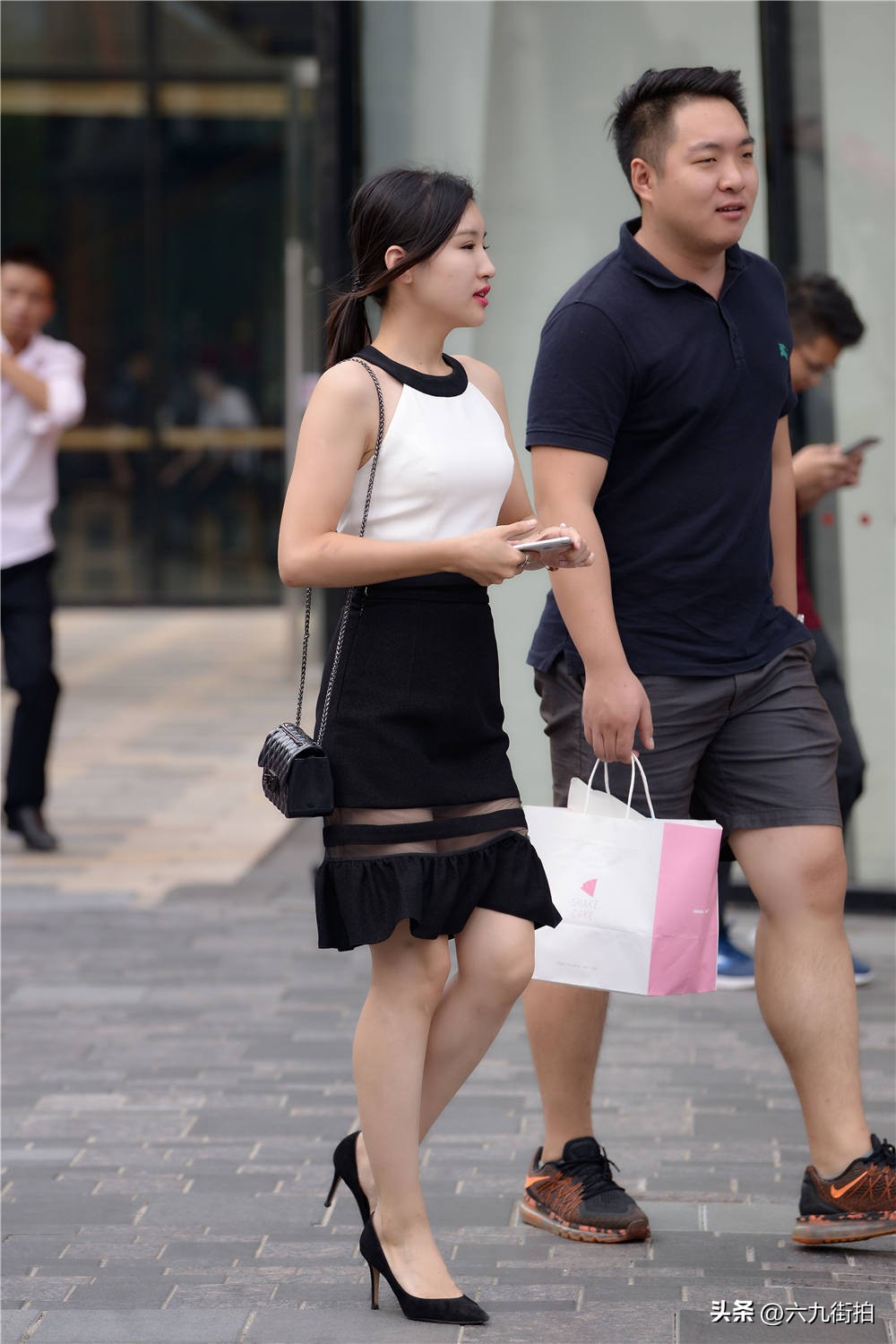 Black pointed-toe stilettos, with a black ruffled high-waisted skirt ...