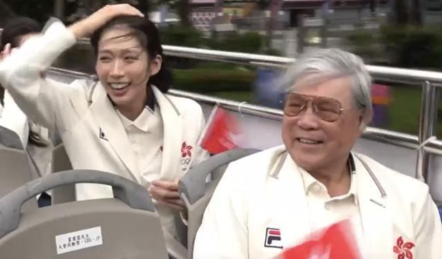 78-year-old Timothy Fok leads the Olympic athletes on a parade, his ...