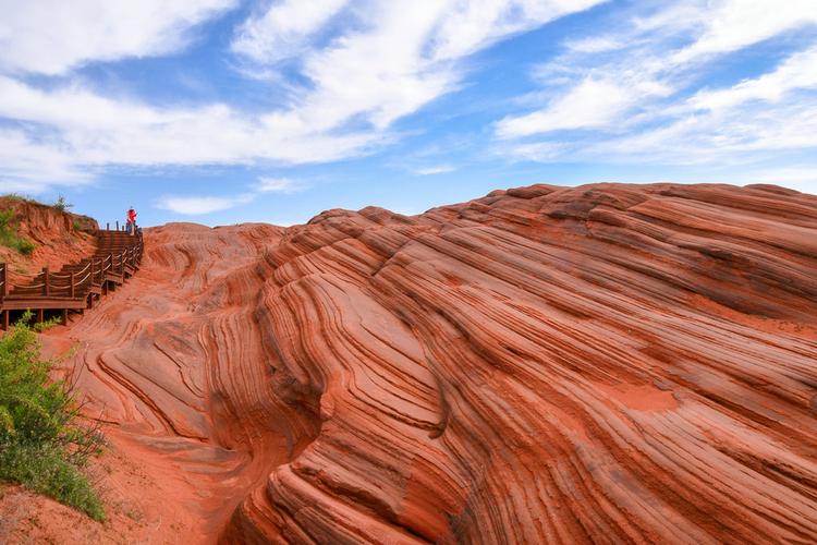 Aerial photography of Wave Valley, tourists stepping on the Danxia ...