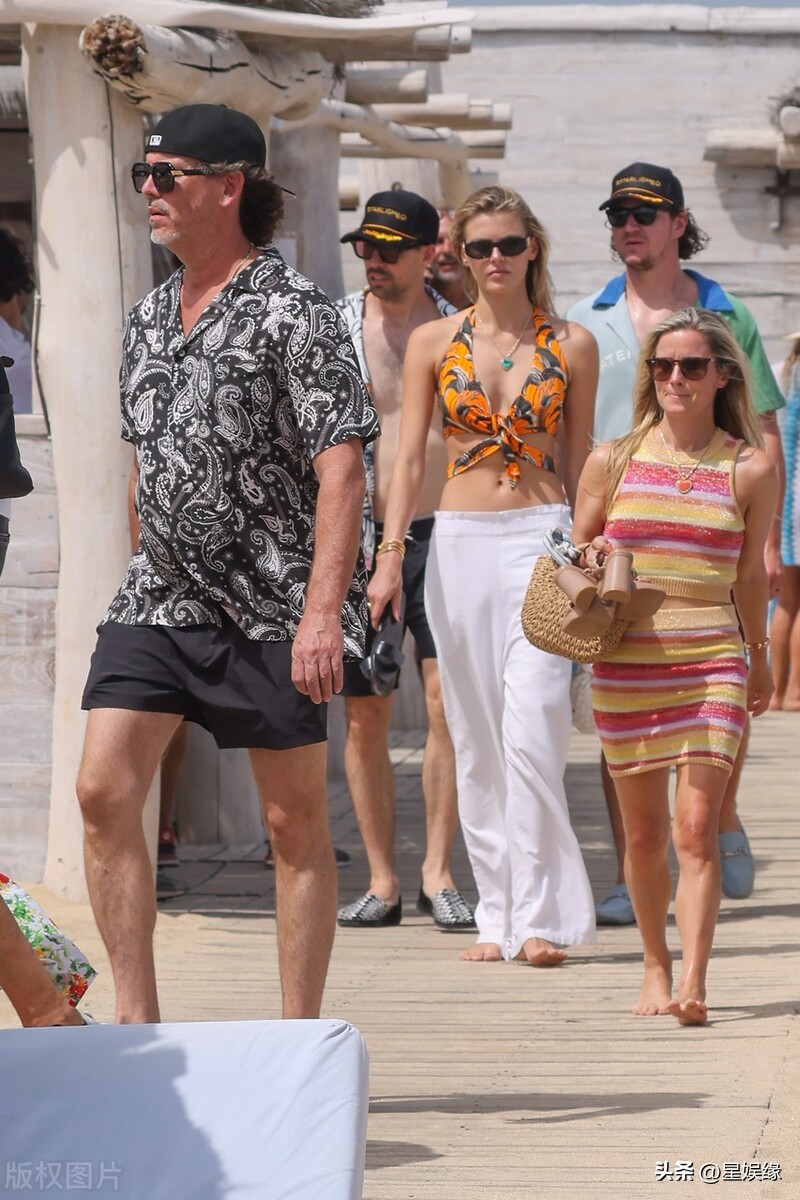 Madison Hedrick is wearing an orange printed halter neck corset + white ...