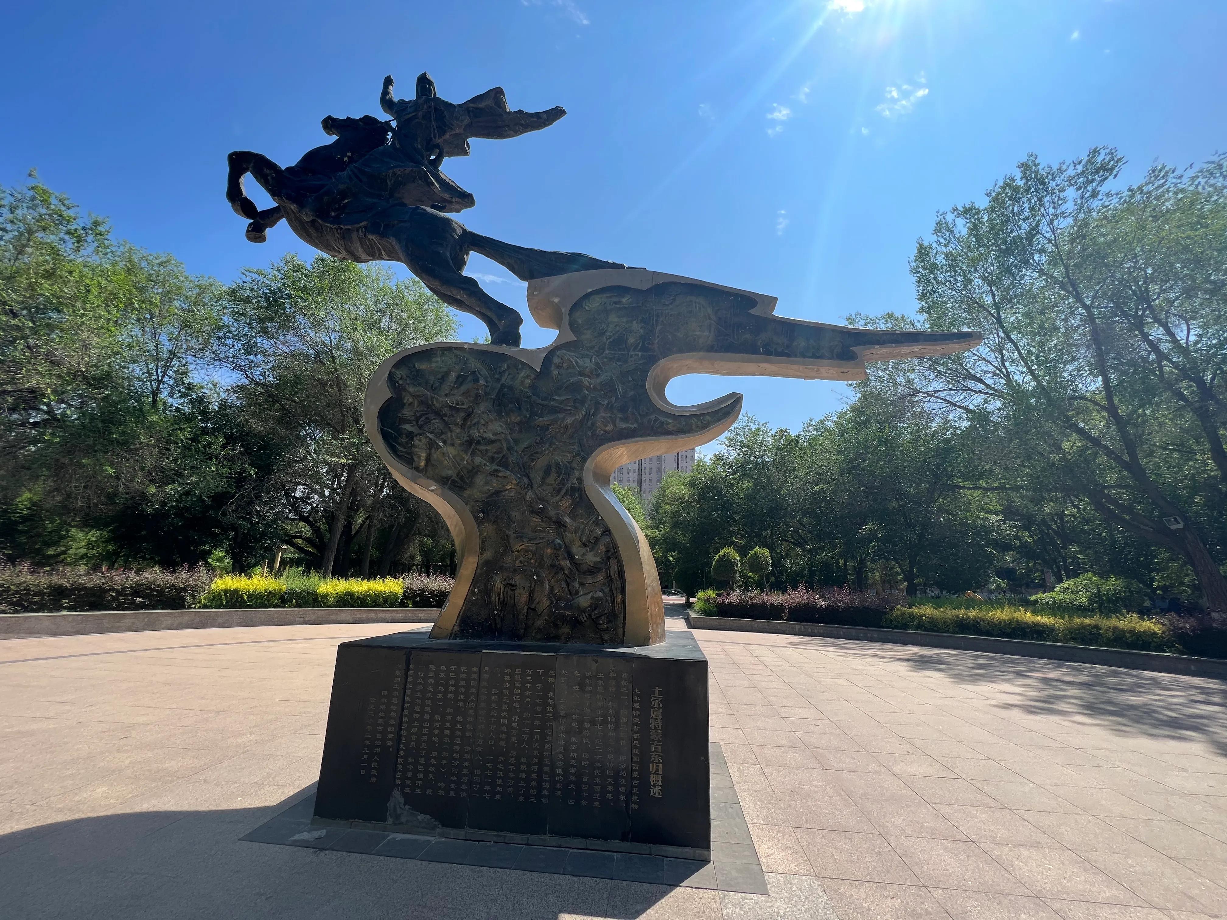 Standing in front of the statue of Ubashi, the leader of the Turhu ...