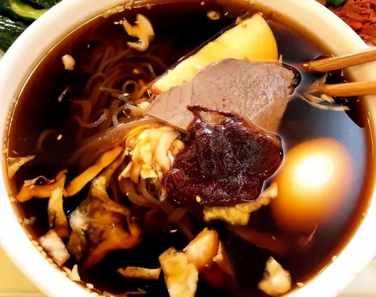 A bowl of Yanji cold noodles, a plate of spicy beef, and a draft of ...