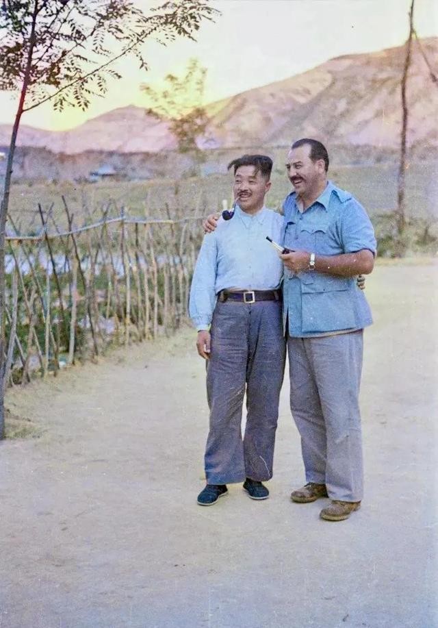 A photo of He Long and an American reporter. He Long has his hair up ...