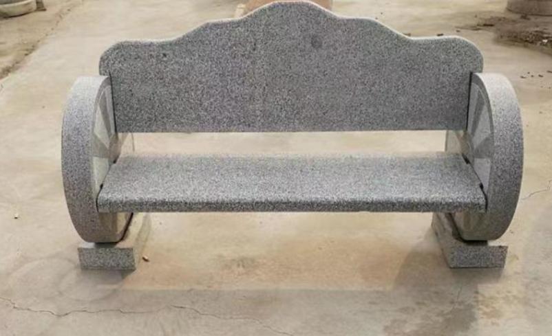 Ancient stone stone chair, carved from a large block of stone, has a ...