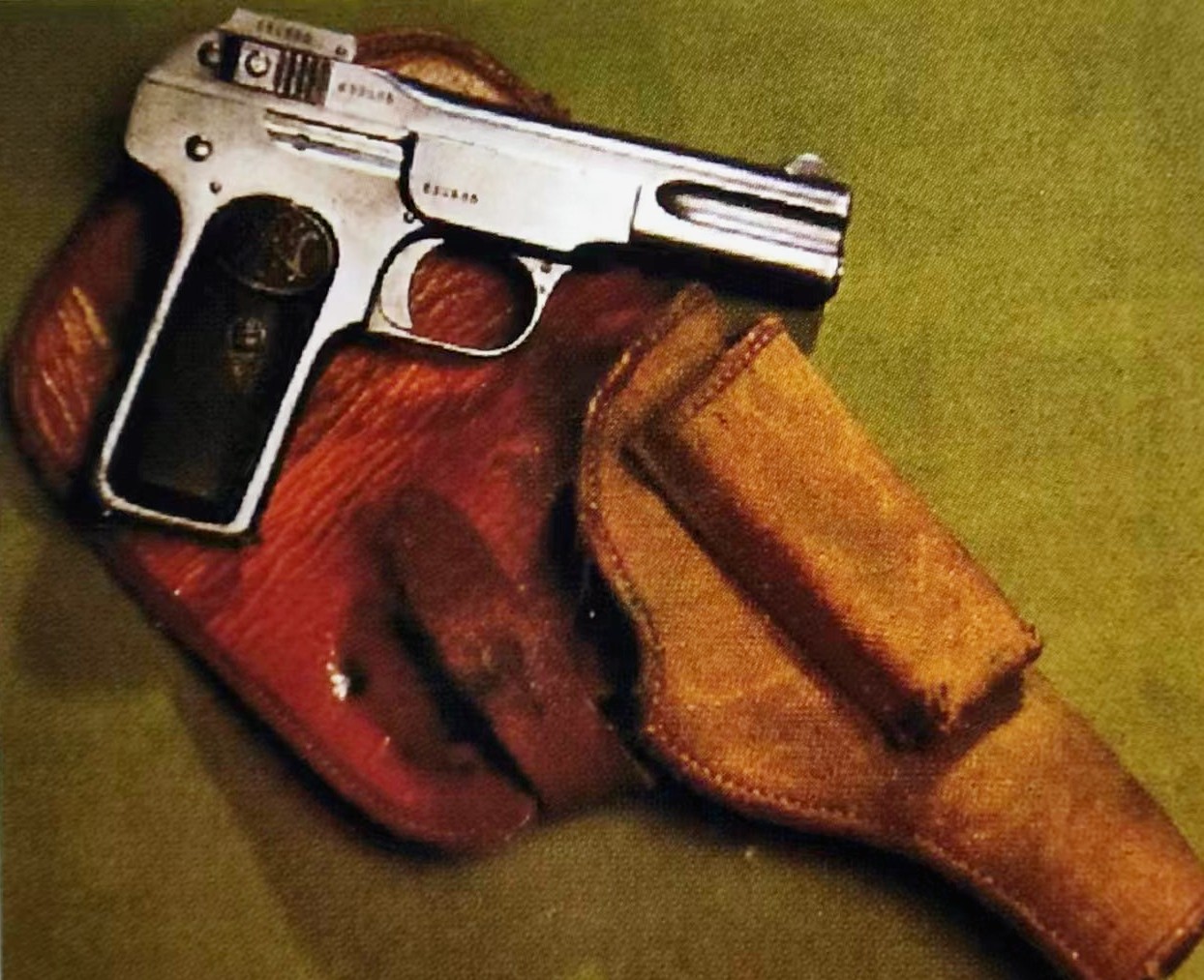 Introduction of Browning FN M1900 automatic pistol in the mouth of two ...