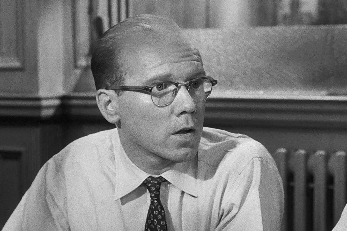 In the film "Twelve Angry Men", how does the director show the complete ...